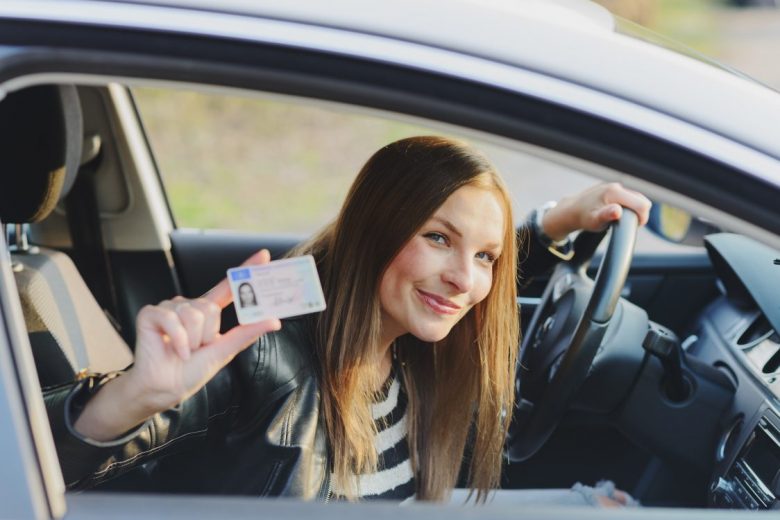 Attractive young woman proudly showing her drivers license – eTags ...